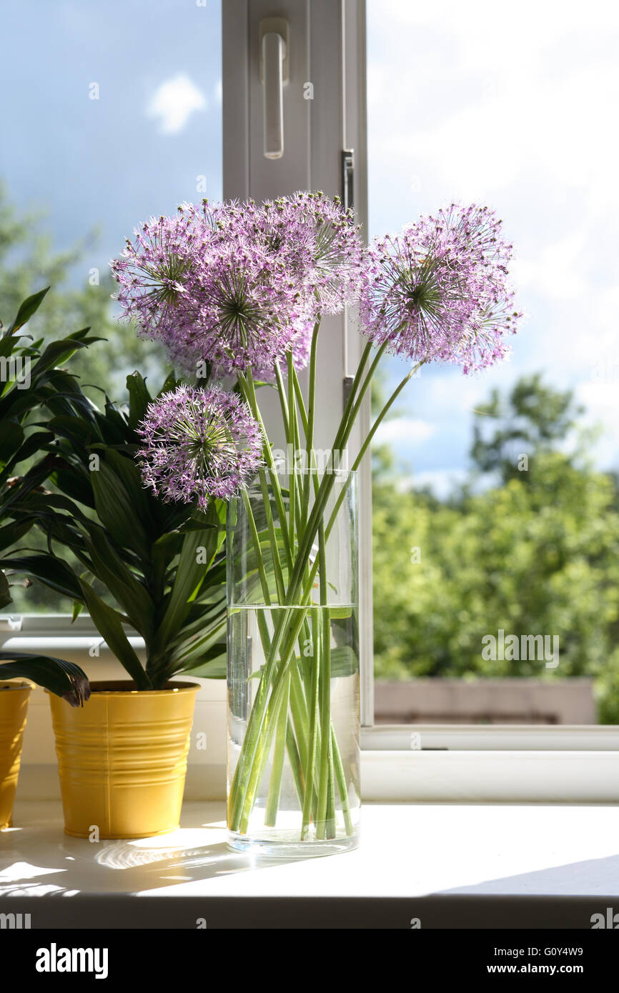 Nice bouquet of flowers in glass vase on window-sill Stock Photo - Alamy