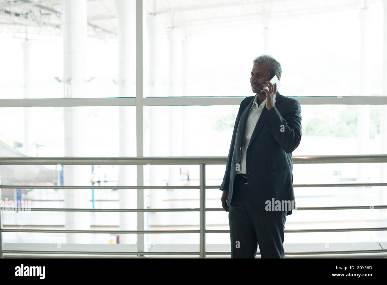 matured indian business male using smartphone Stock Photo - Alamy