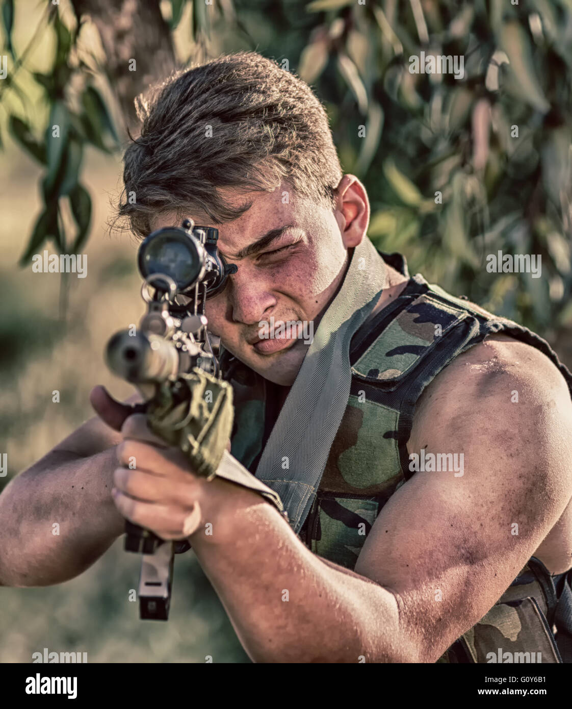 young a soldier in the uniform with weapon Stock Photo - Alamy