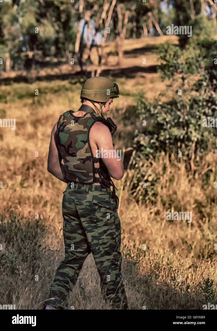 young a soldier in the uniform with weapon Stock Photo - Alamy