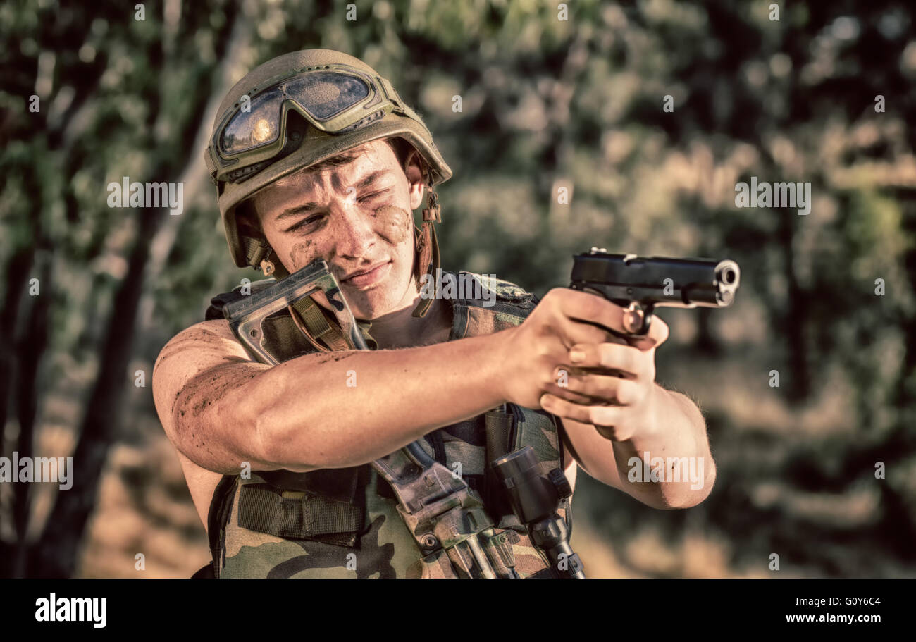 young a soldier in the uniform with weapon Stock Photo - Alamy
