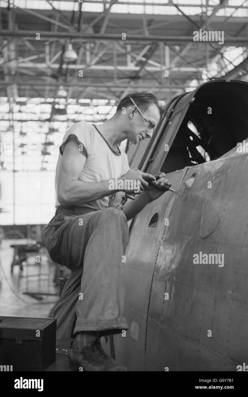 Worker Riveting a Fuselage on a Sub-Assembly Line, Vultee Aircraft ...