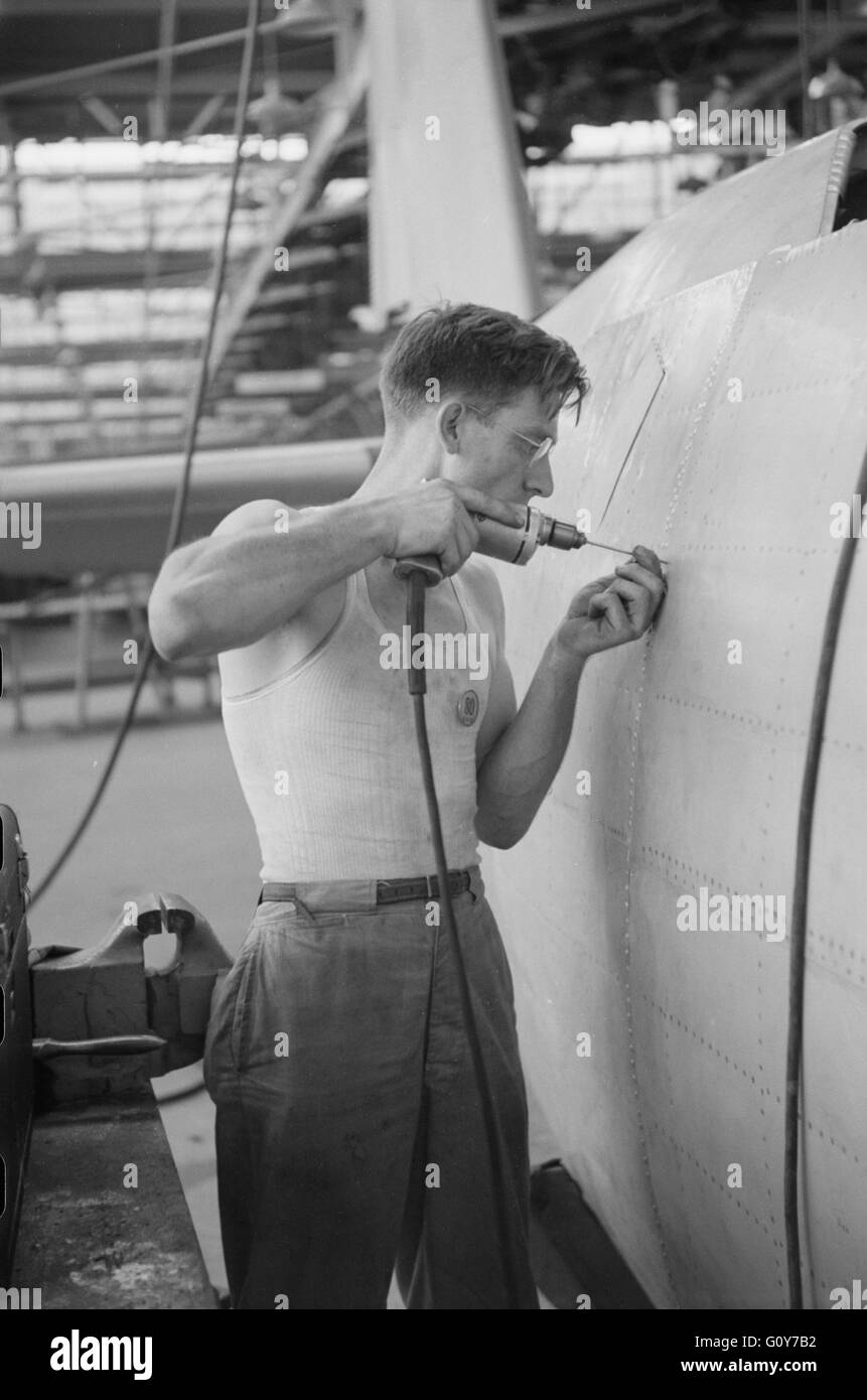 Worker Drilling Holes for Rivets in a Fuselage on a Sub-Assembly Line ...