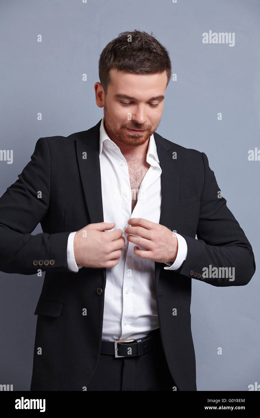 young businessman adjusts his clothes Stock Photo - Alamy