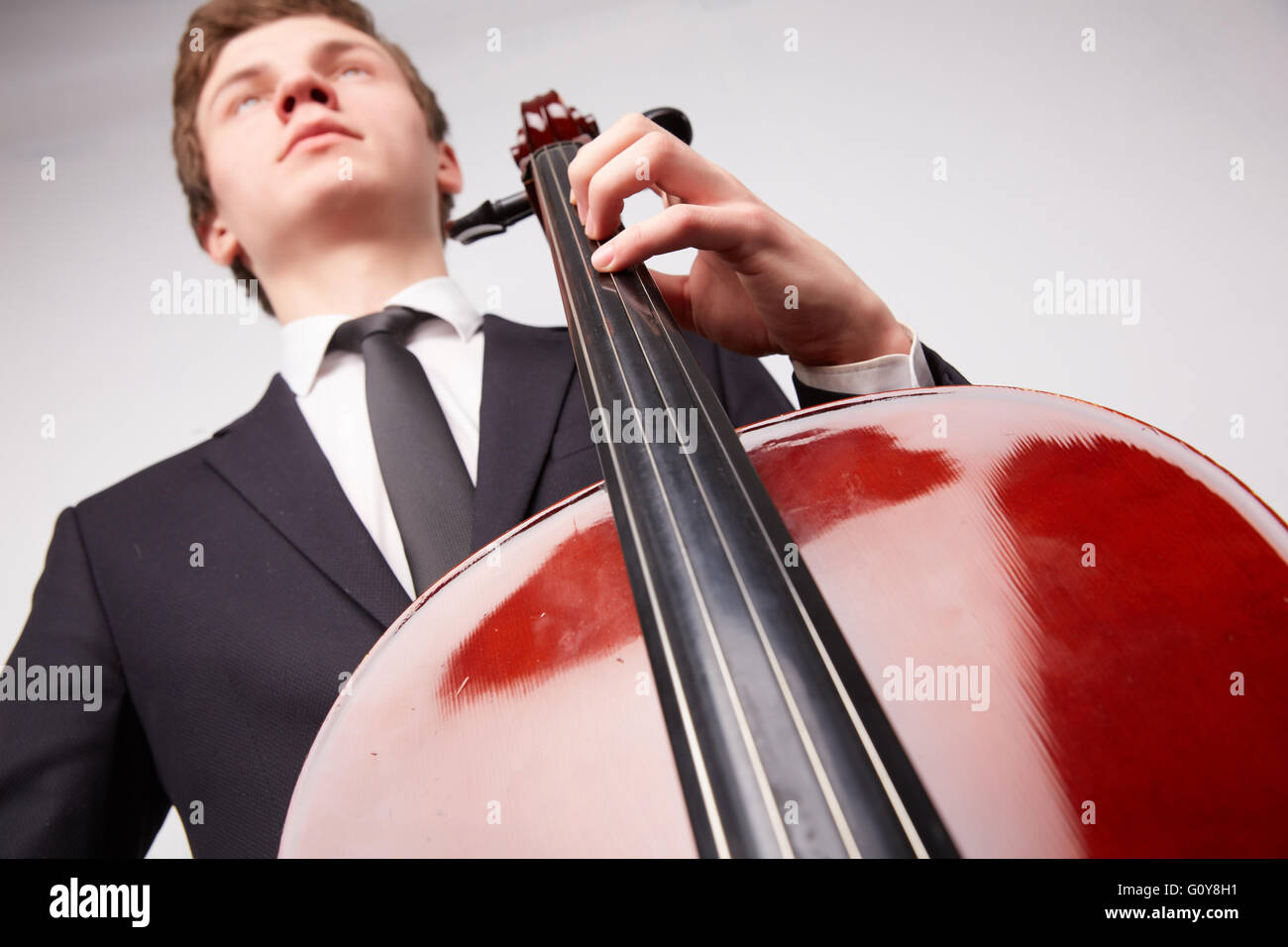 young man with a cello Stock Photo - Alamy