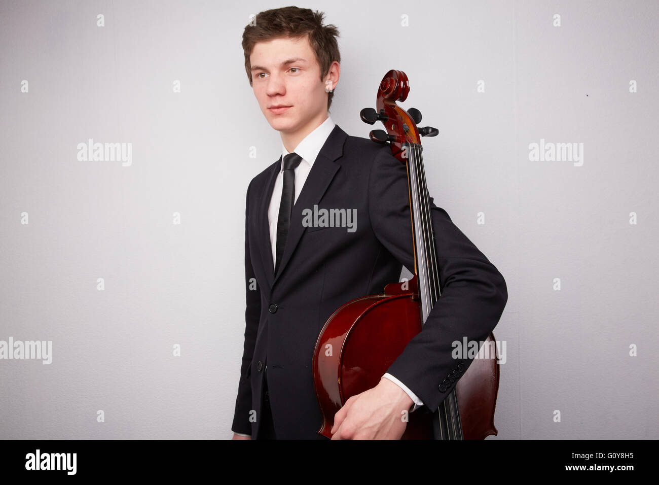 young man with a cello Stock Photo - Alamy