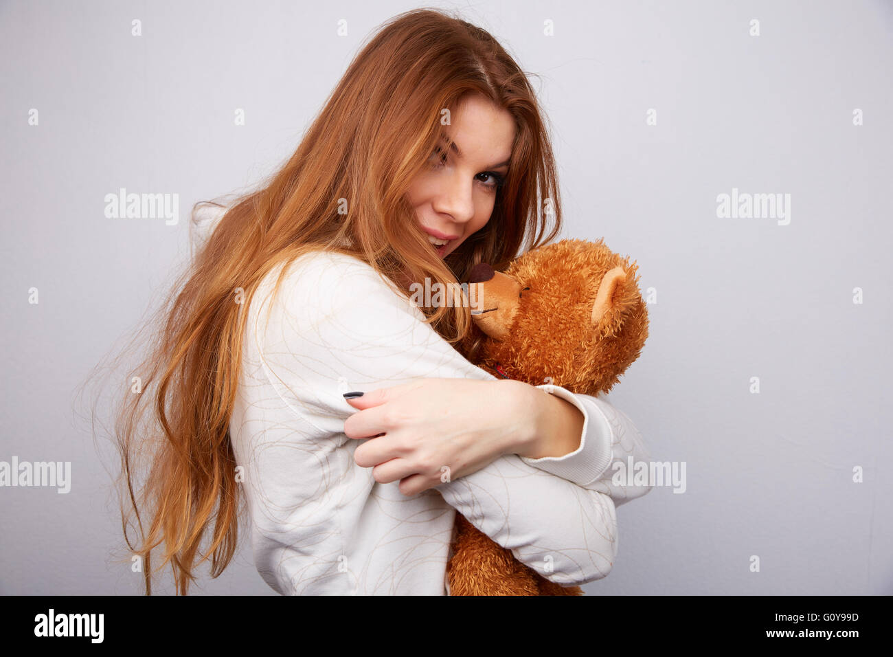 red-haired woman with a teddy bear Stock Photo - Alamy