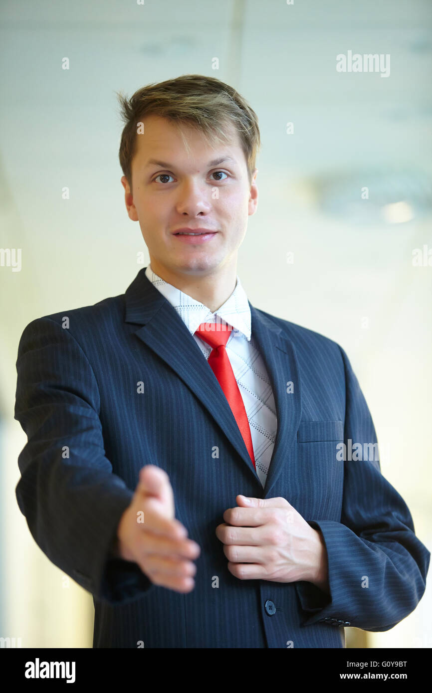 Businessman gives a hand Stock Photo - Alamy