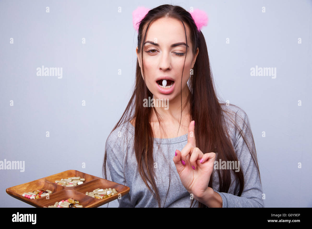 fun girl drinks a lot of pills Stock Photo - Alamy