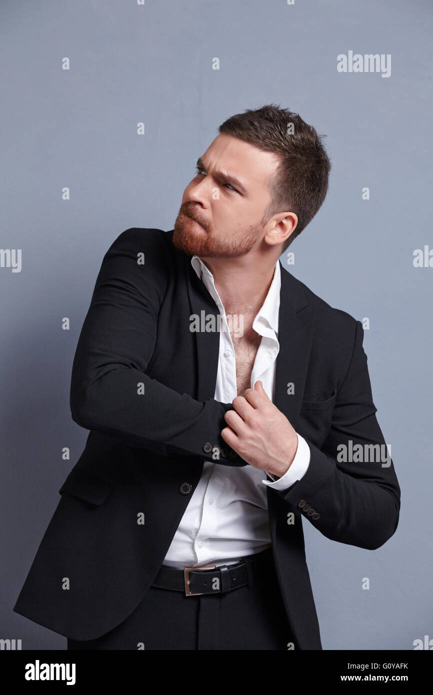 businessman puts his hand inside his jacket Stock Photo - Alamy