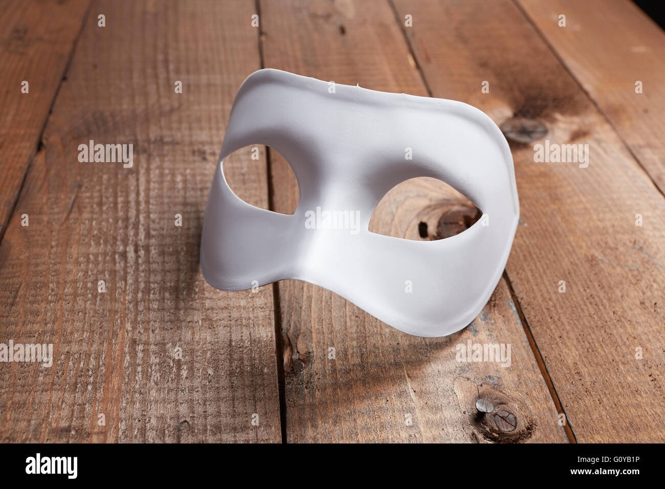 White Venetian mask on the table Stock Photo - Alamy