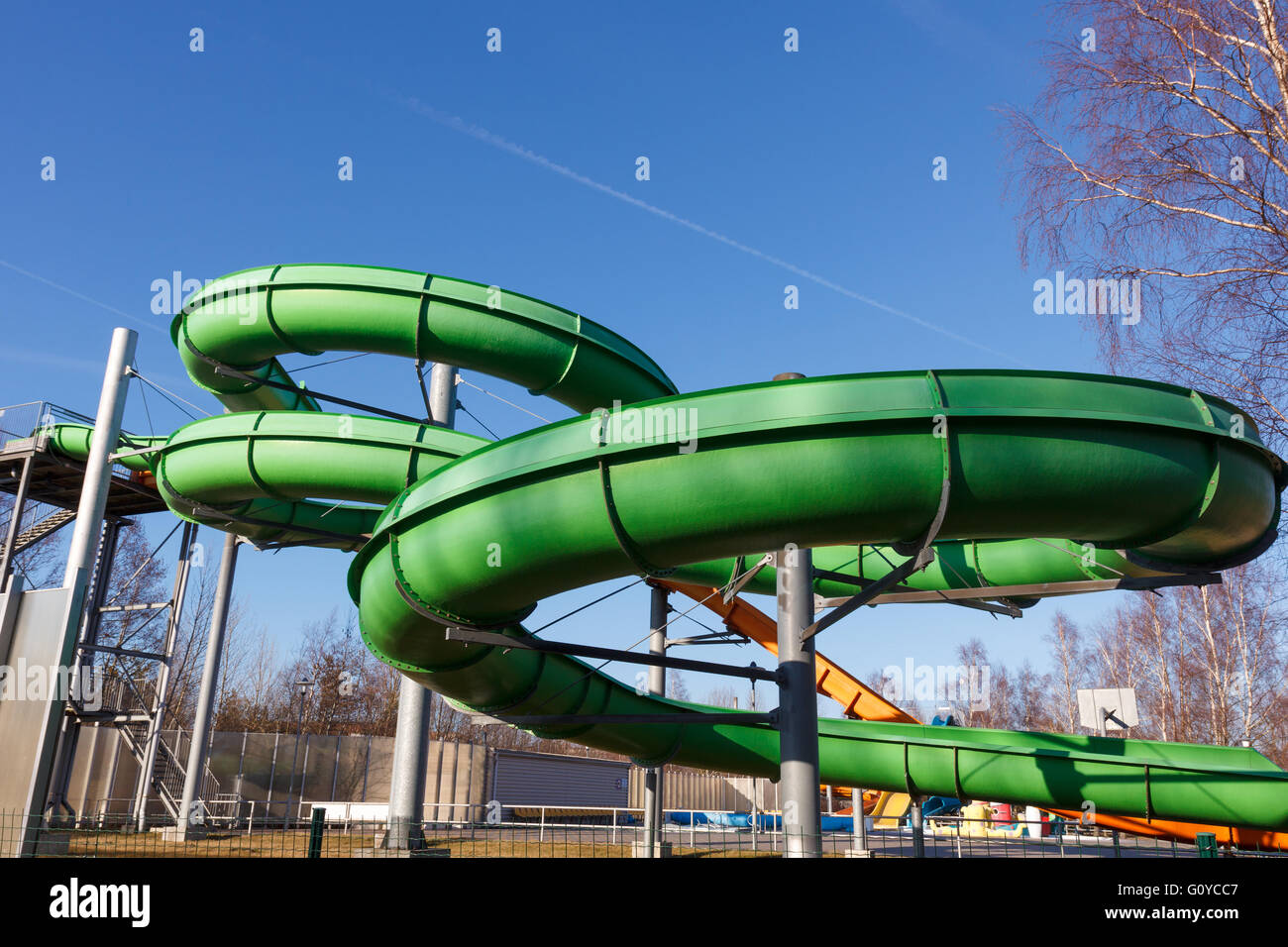 Green outdoors waterslide Stock Photo - Alamy