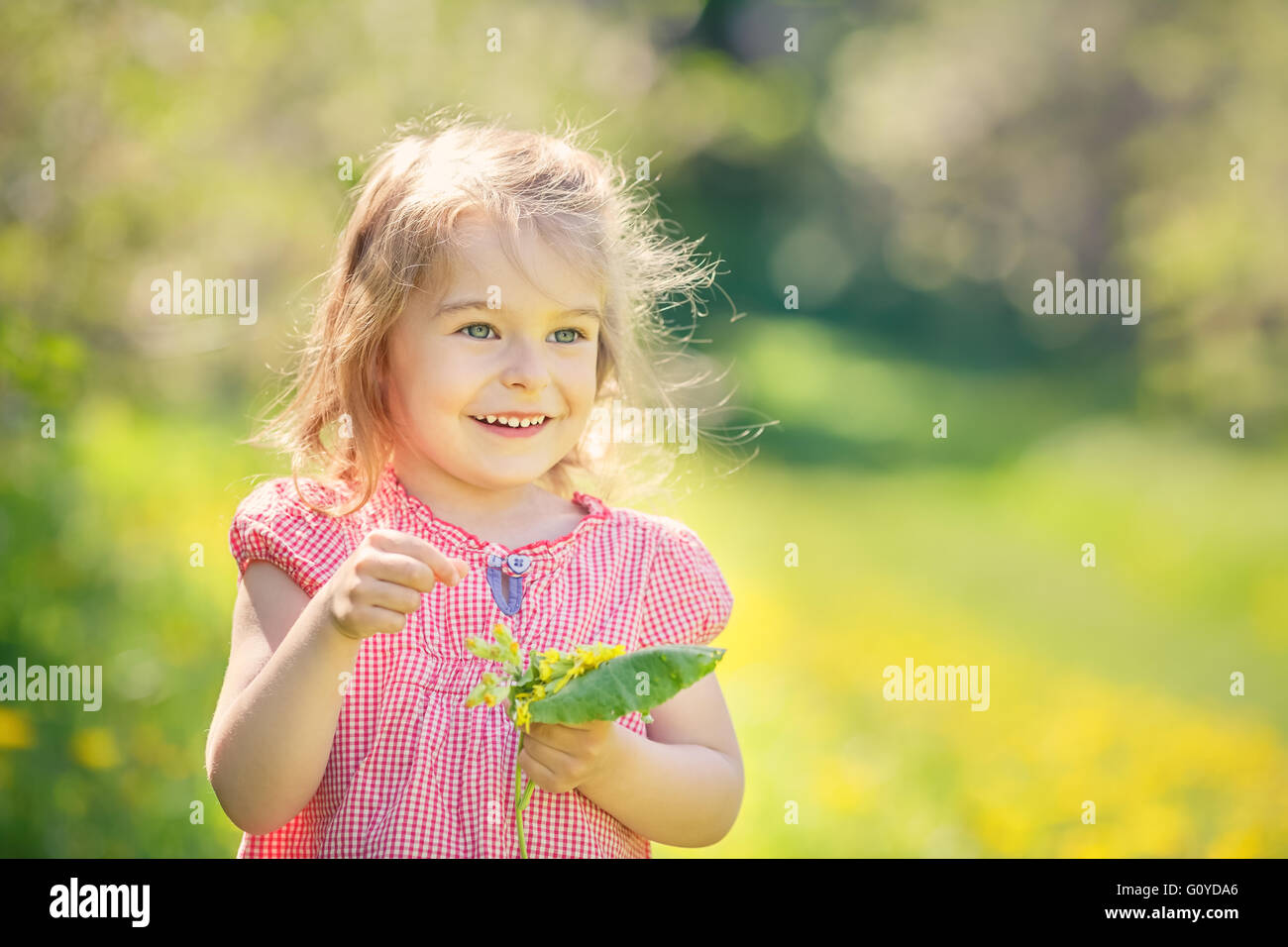 Happy little girl in spring sunny park Stock Photo - Alamy
