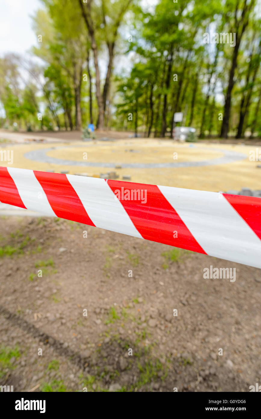 Red and white striped tape defining the border of a dangerous zone of ...