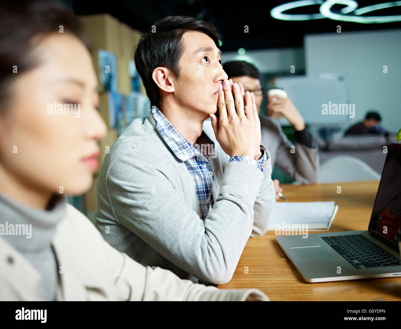 young asian businessman thinking during meeting Stock Photo - Alamy