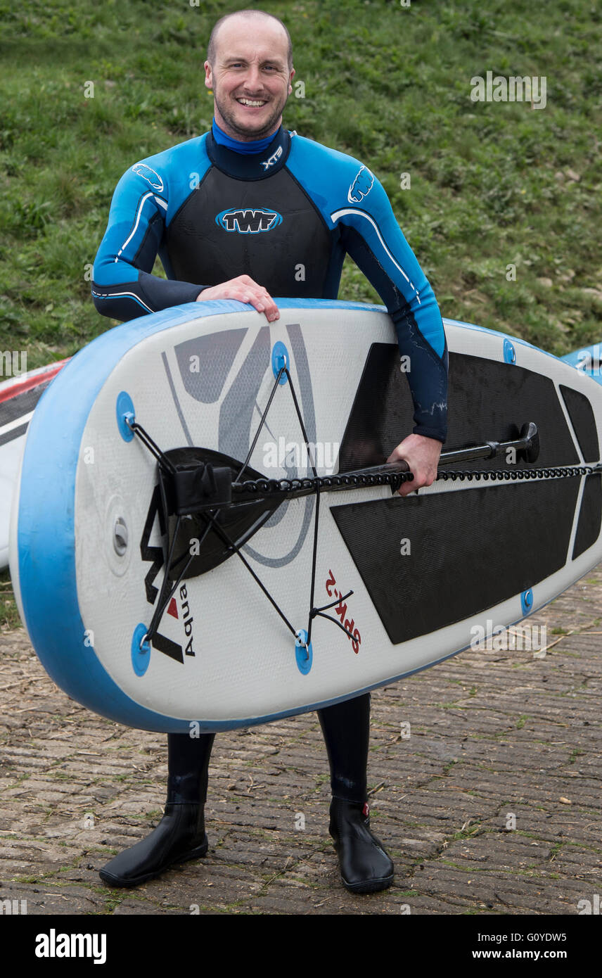 Male paddle boarder poses with kit Stock Photo - Alamy