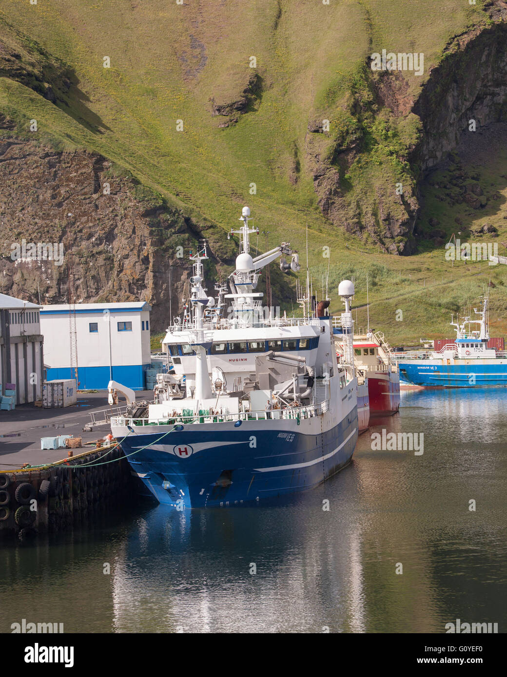 August 3, 2015 - Fishing trawlers in Heimaey harbor beneath the ...