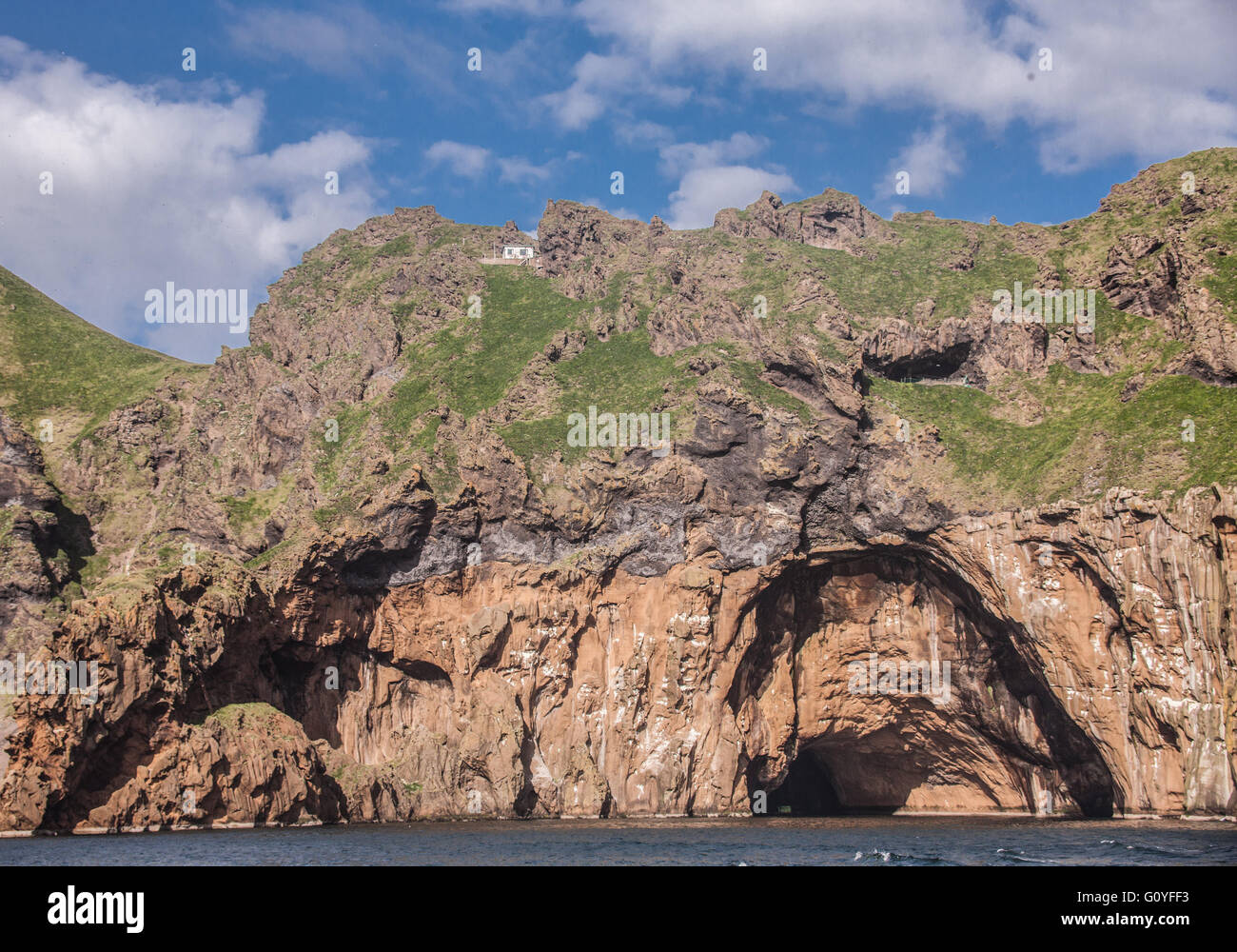 August 3, 2015 - The much visited Klettshellir Cave below rugged ...