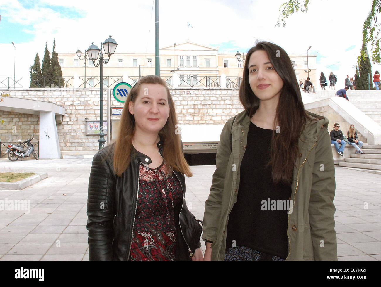 Students Elena (27) and Juli (R, 25) stand in front of the Greek ...