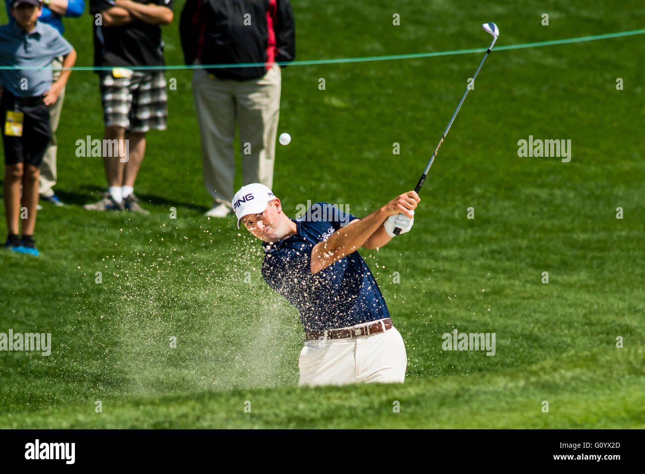 Golfer Michael Thompson plays a shot from a green side bunker on the ...