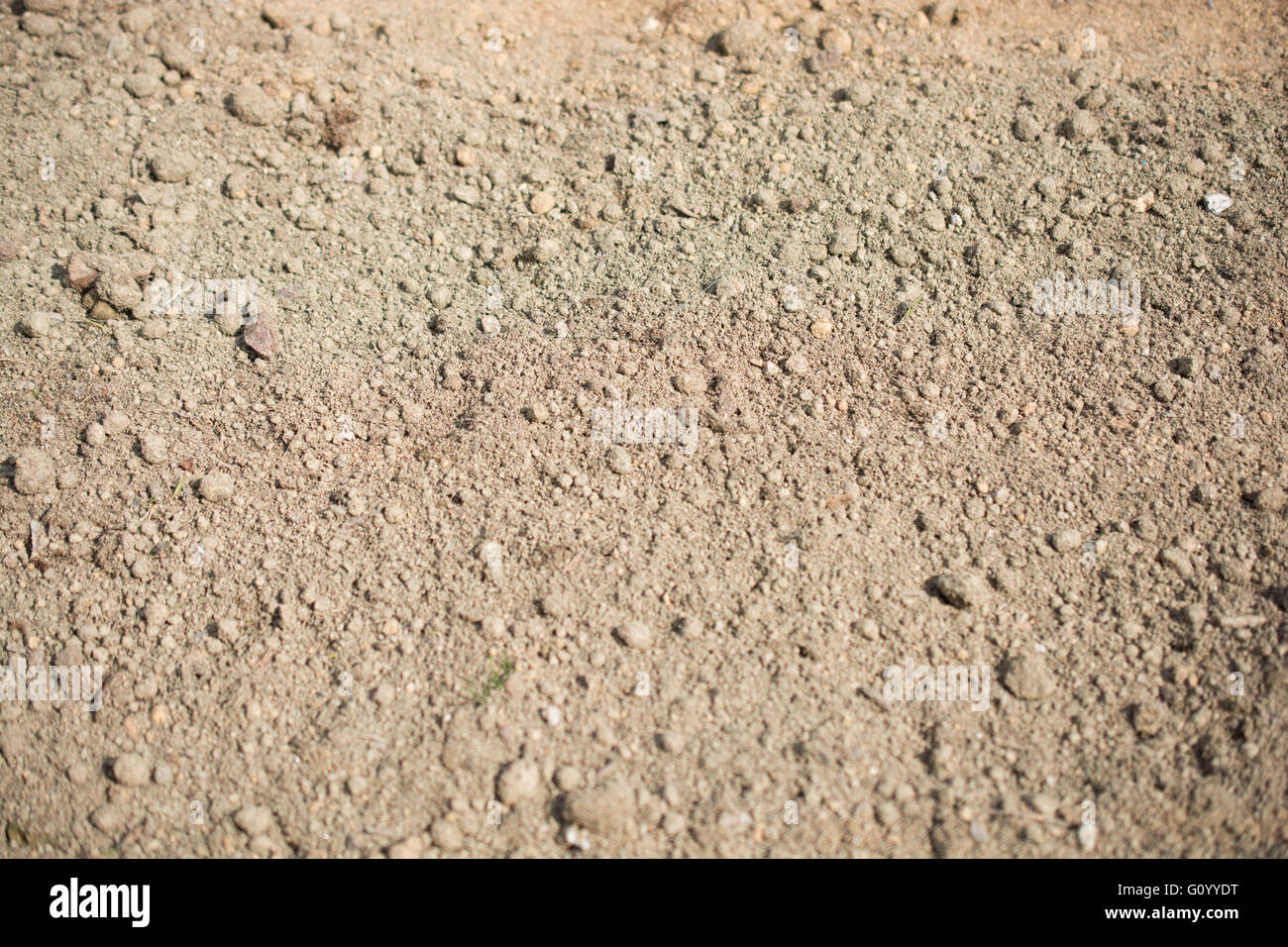 Brown lumpy soil in a shady light as a background Stock Photo - Alamy