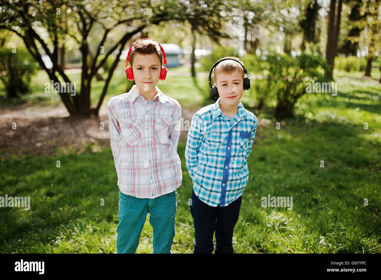 Two brother boy with headphones on park. Brother love Stock Photo - Alamy