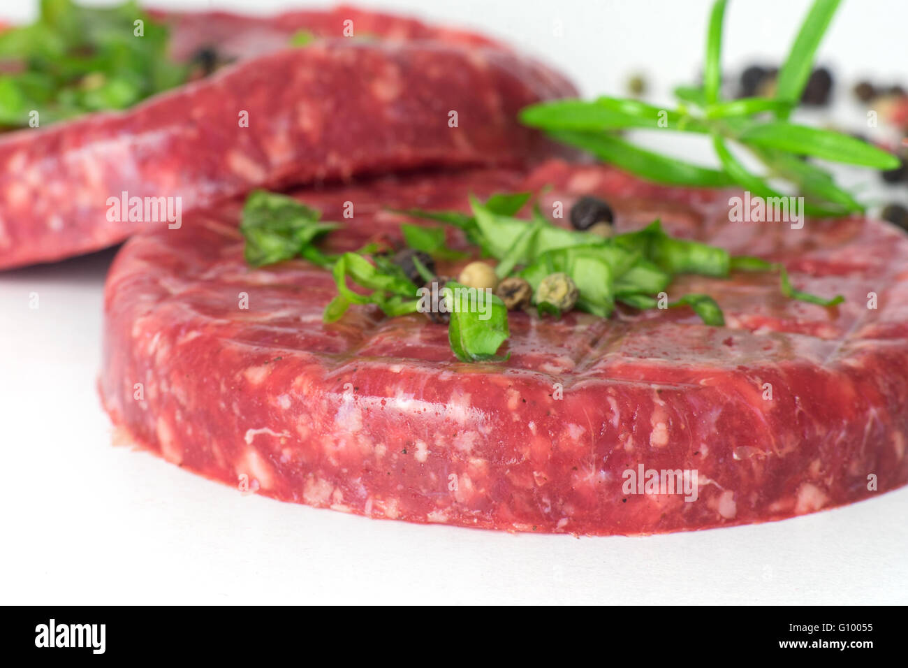 Raw beef hamburger isolated on white background Stock Photo - Alamy