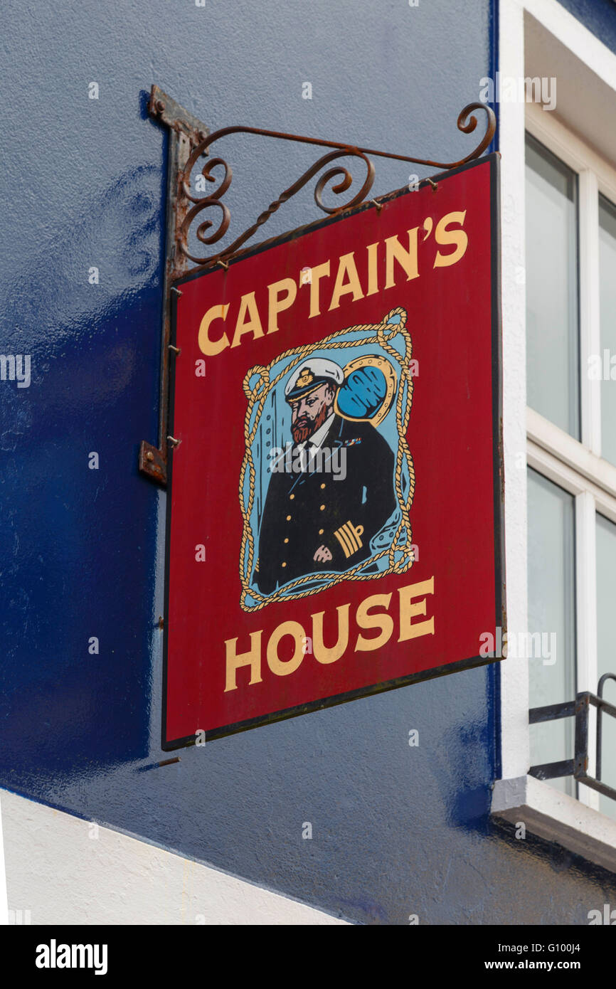Colorful sign with the illustration of a captain, in Dingle Town ...