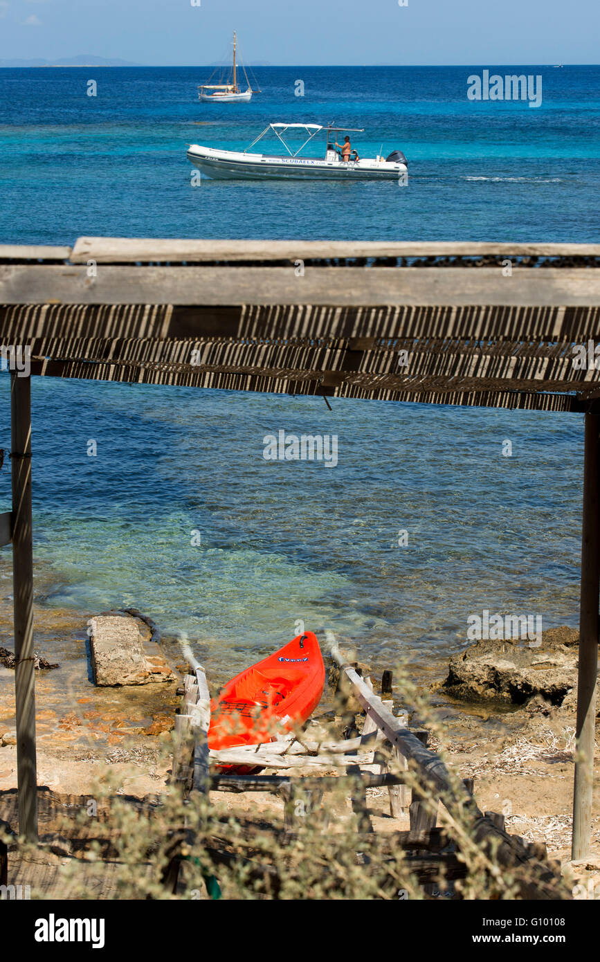 Els Pujols beach in Formentera with traditional fishing boat and kayaks ...