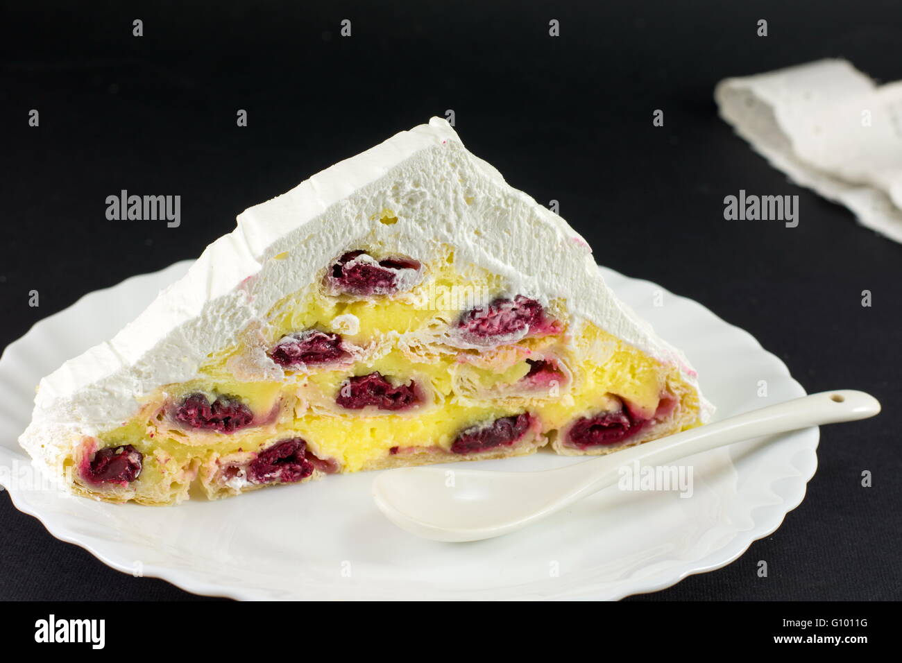 triangle cherry cake on black background Stock Photo - Alamy