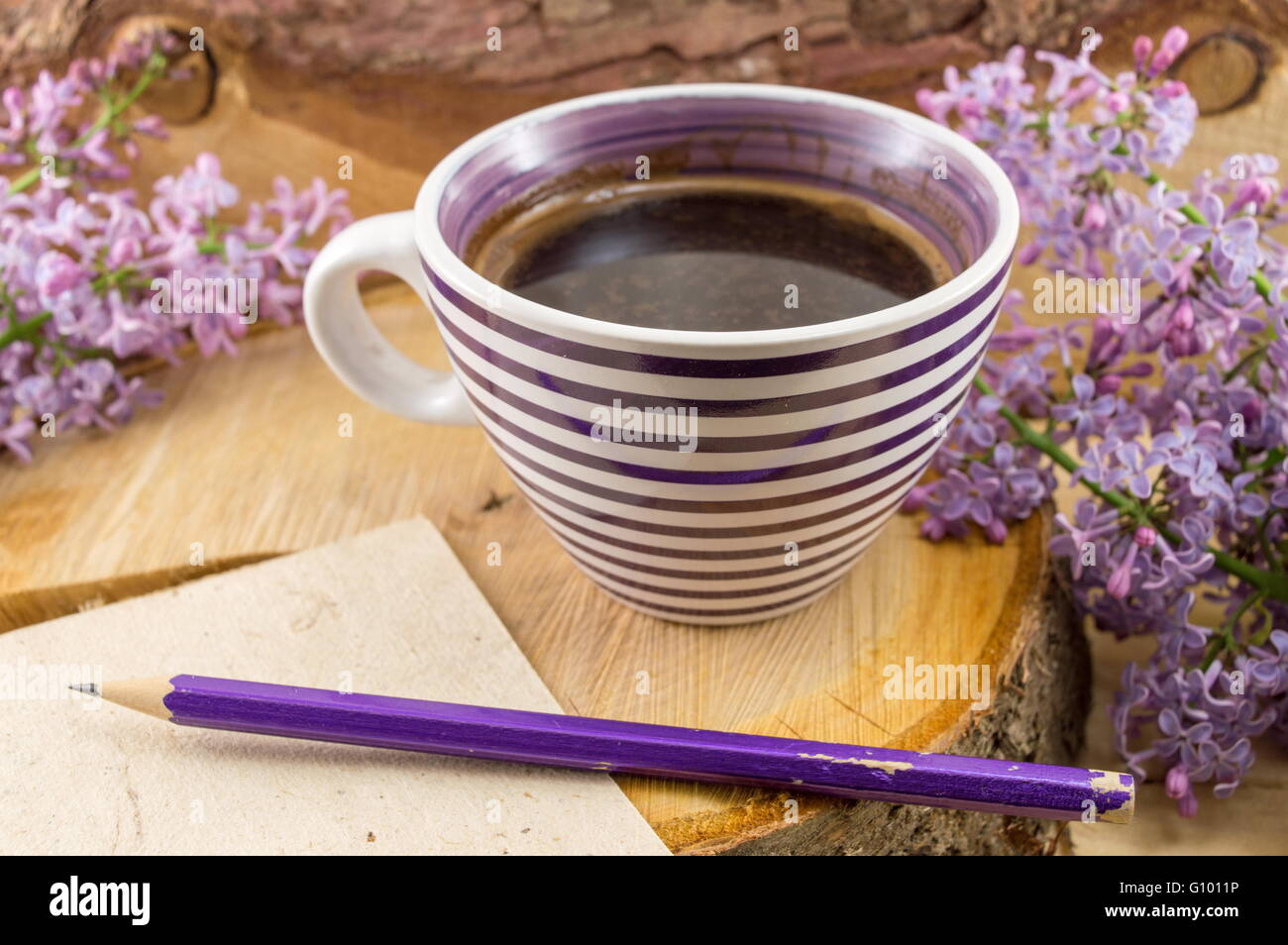 Cup of coffee and purple spring flowers Stock Photo - Alamy