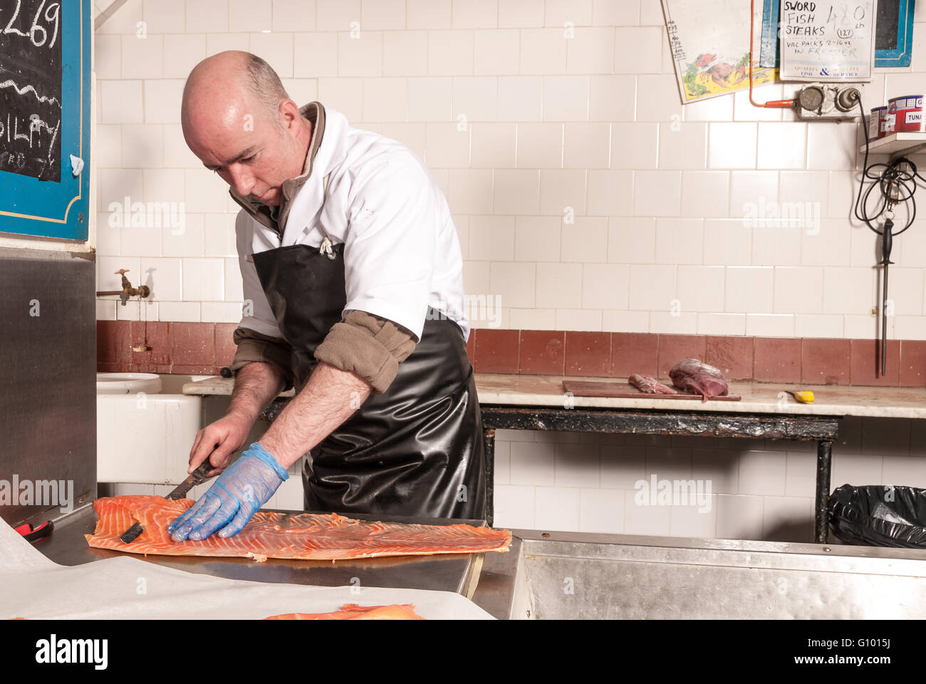 Fishmonger cutting smoked salmon slices, UK Stock Photo - Alamy