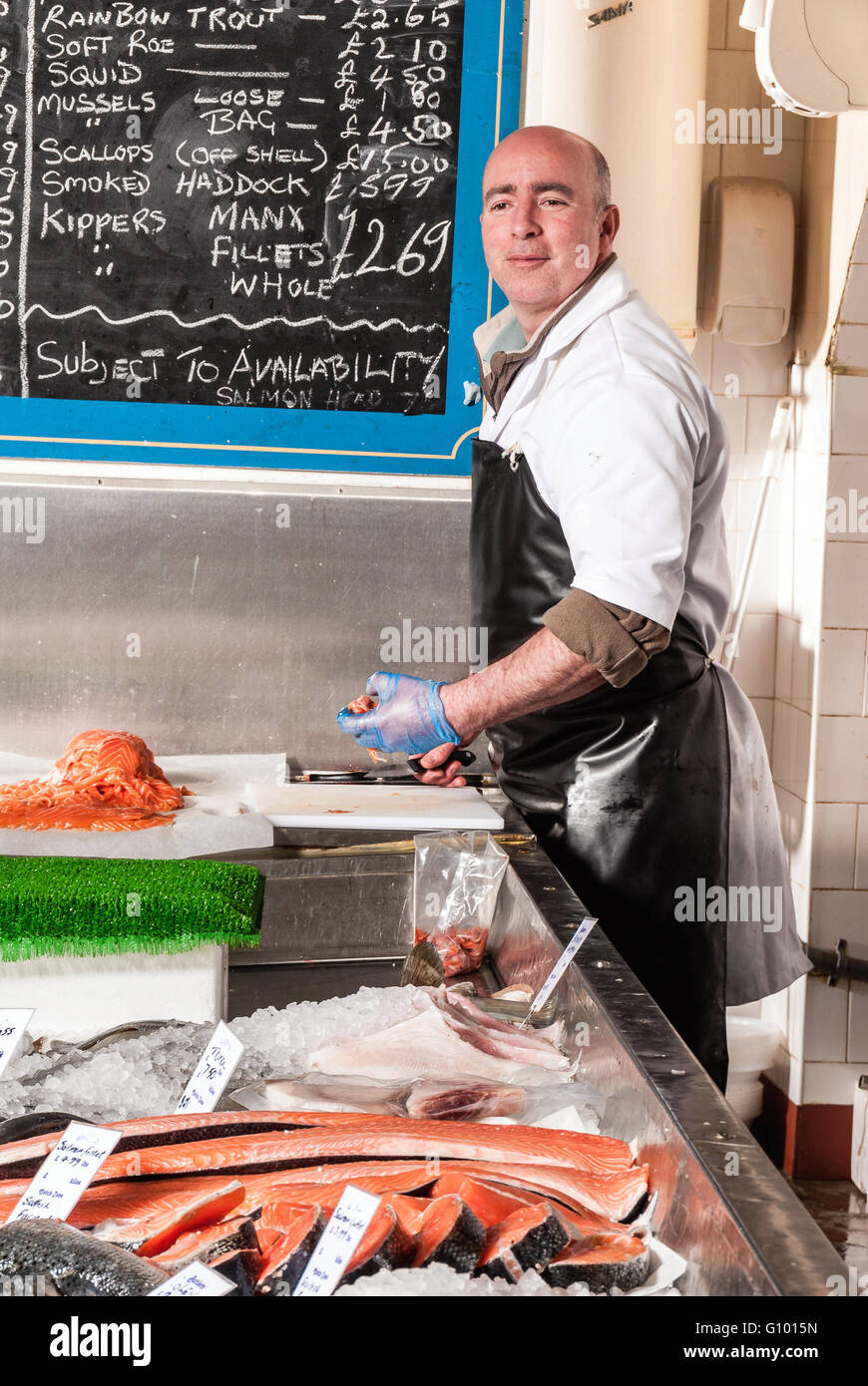 Fishmonger packaging freshly sliced smoked salmon, UK Stock Photo - Alamy