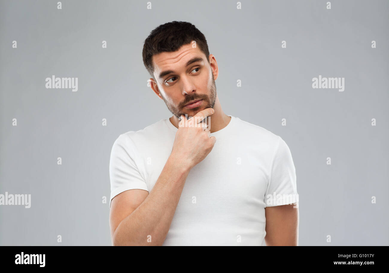 man thinking over gray background Stock Photo - Alamy