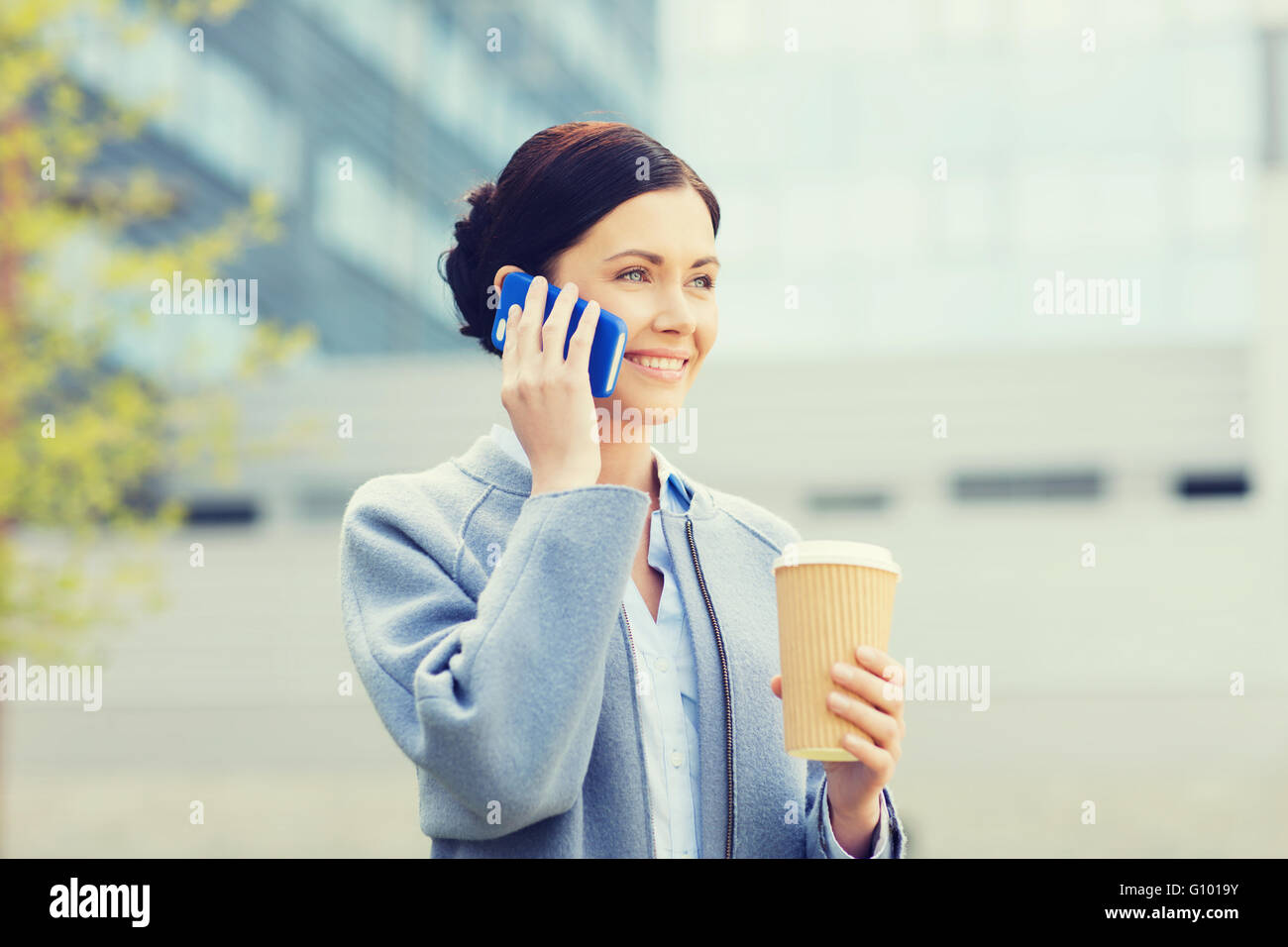 smiling woman with coffee calling on smartphone Stock Photo - Alamy
