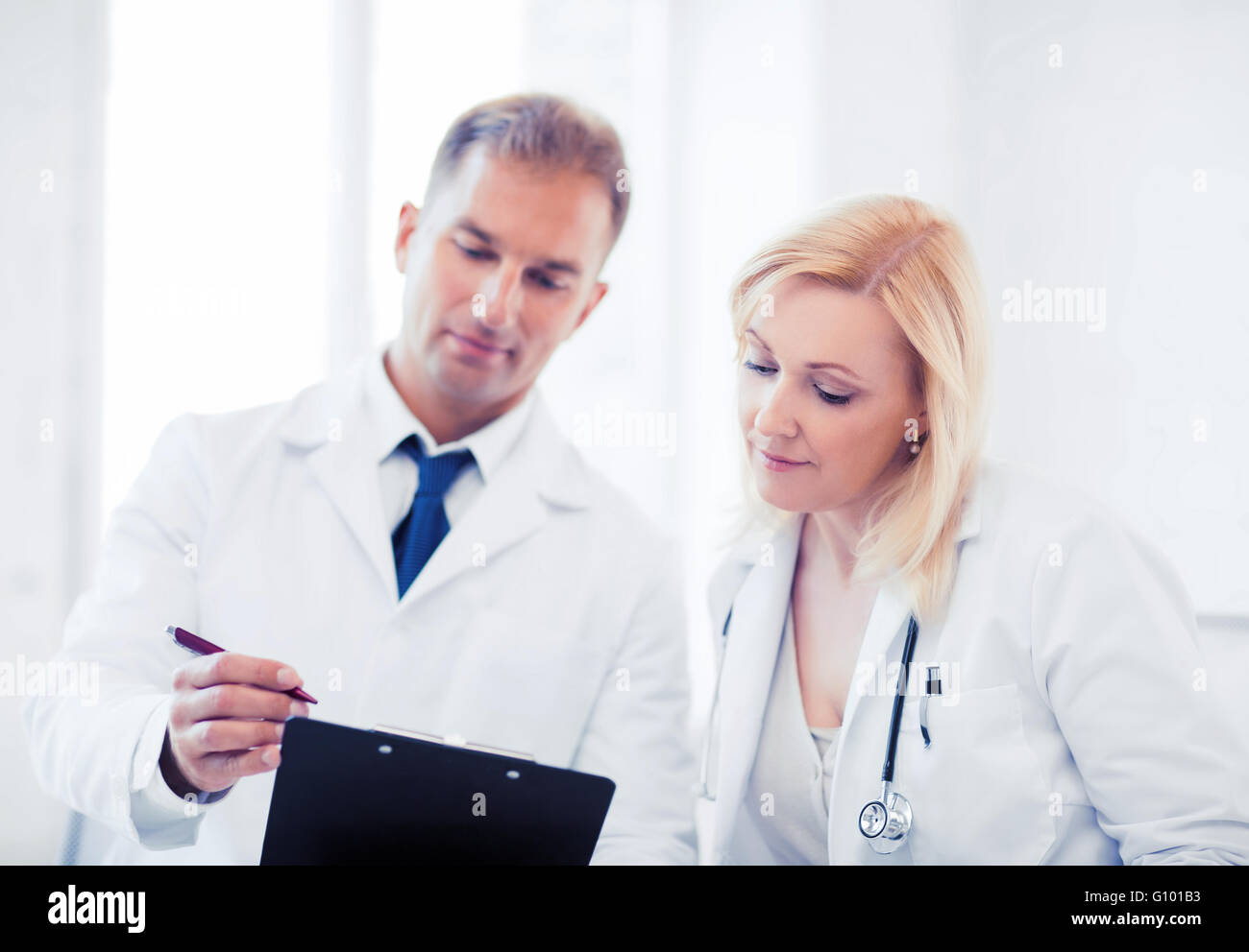 two doctors writing prescription Stock Photo - Alamy