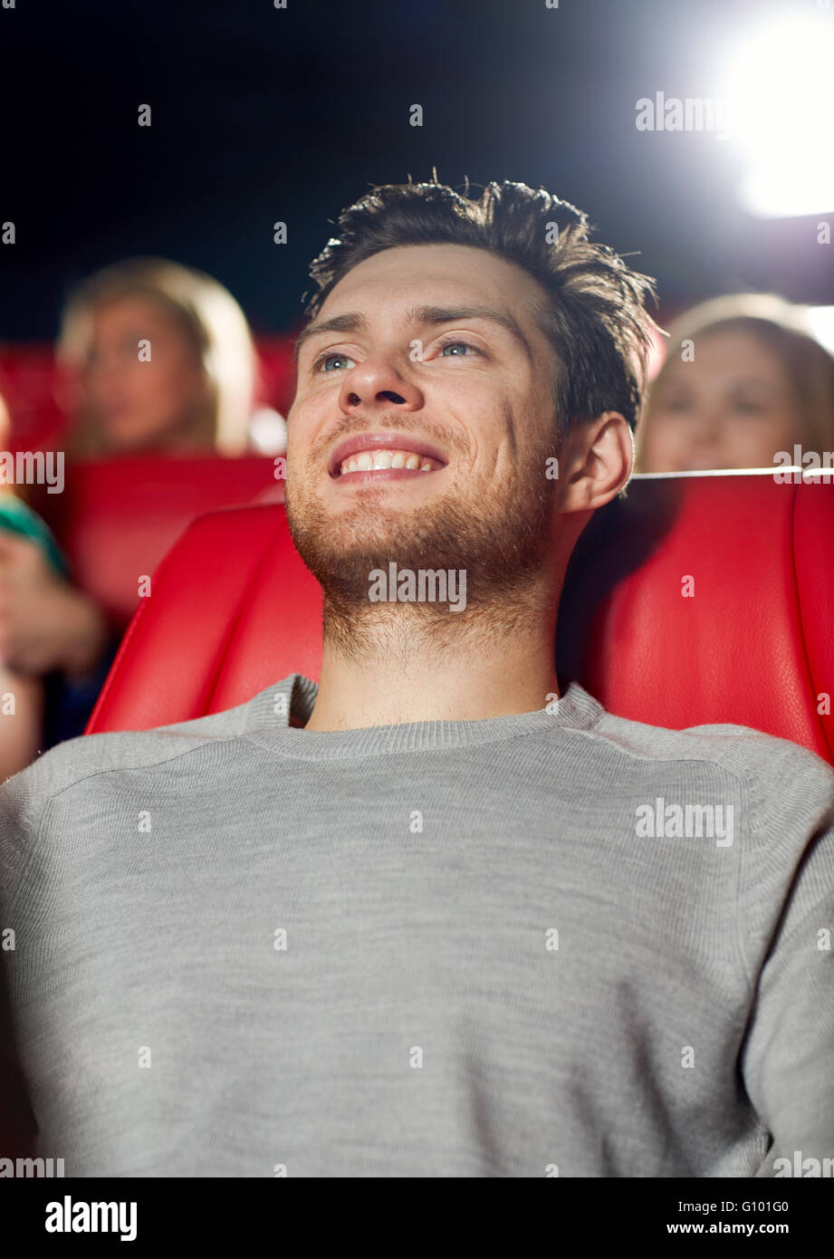 happy young man watching movie in theater Stock Photo - Alamy