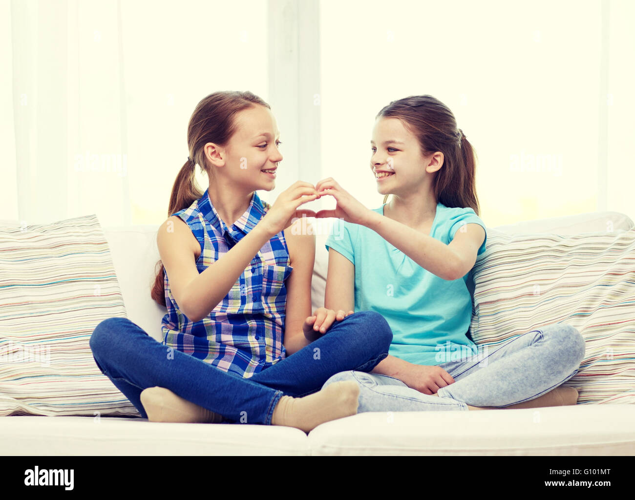 happy little girls showing heart shape hand sign Stock Photo - Alamy