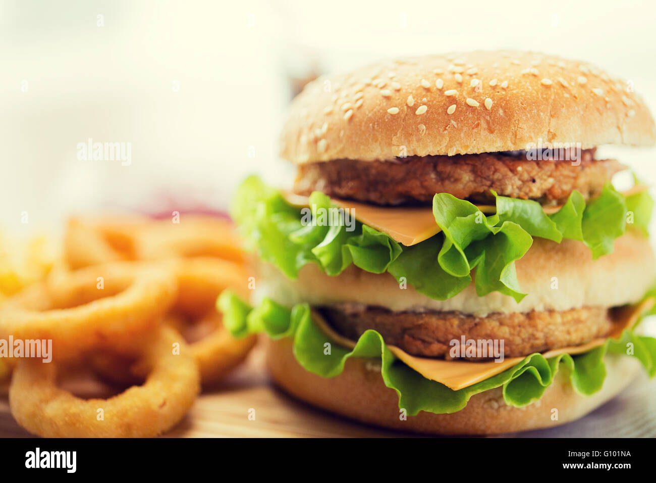 close up of hamburger or cheeseburger on table Stock Photo - Alamy