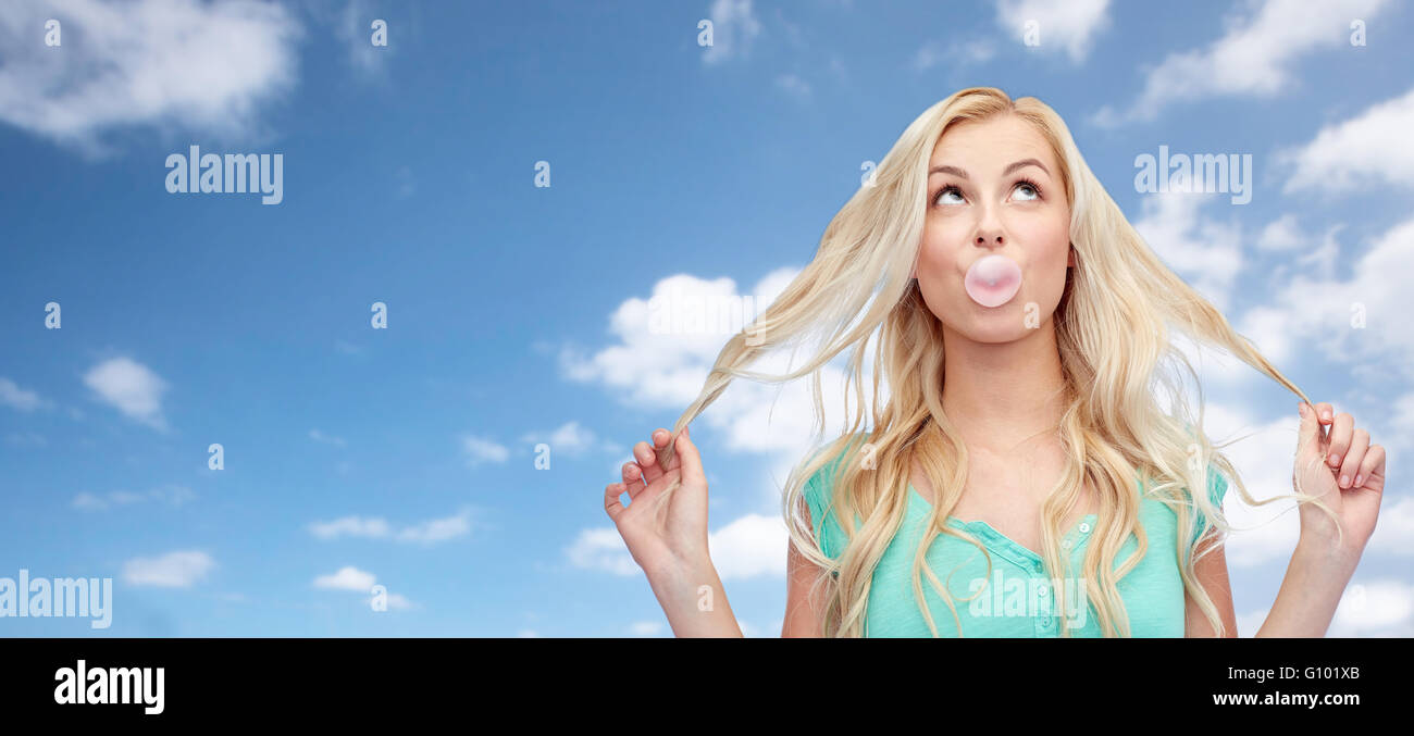 happy young woman or teenage girl chewing gum Stock Photo - Alamy