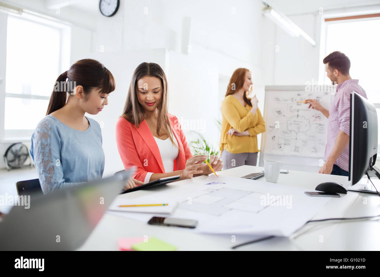 happy creative team with tablet pc at office Stock Photo - Alamy