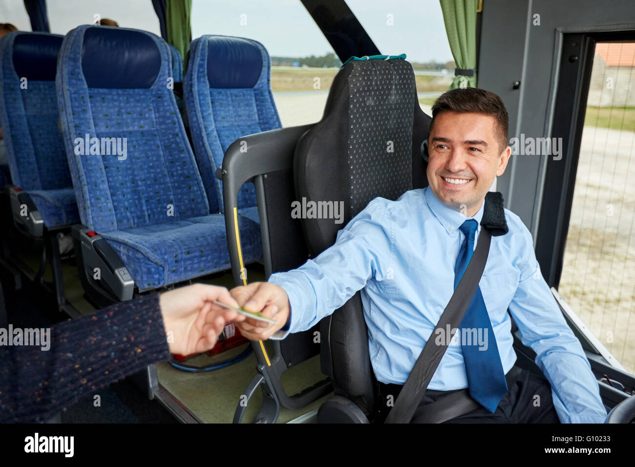 bus driver taking ticket or card from passenger Stock Photo - Alamy