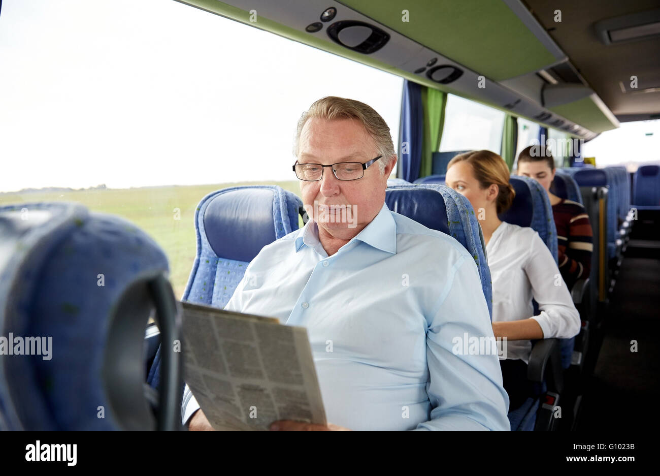 happy senior man reading newspaper in travel bus Stock Photo - Alamy