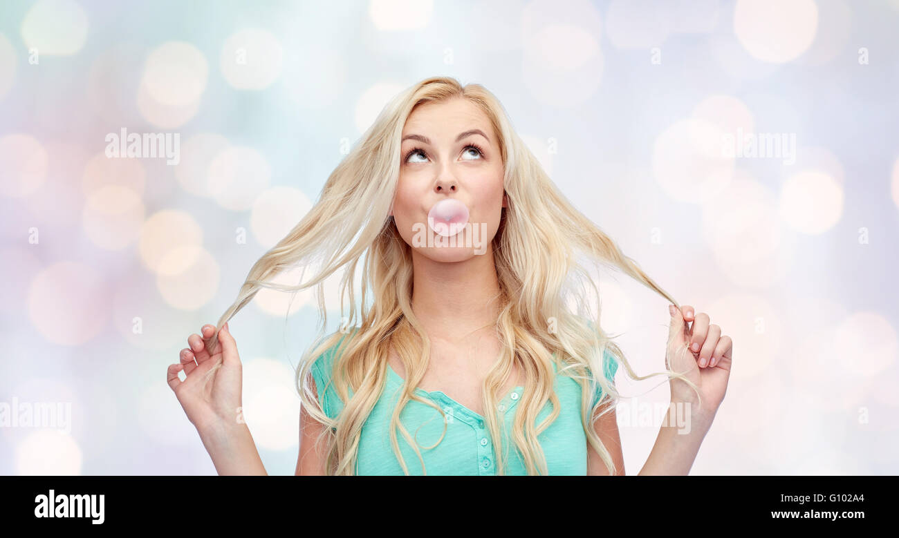 happy young woman or teenage girl chewing gum Stock Photo - Alamy