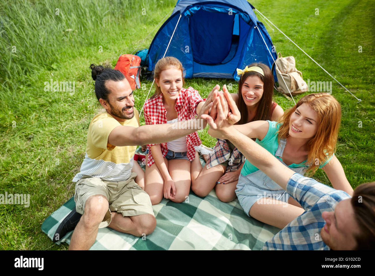happy friends making high five at camping Stock Photo - Alamy