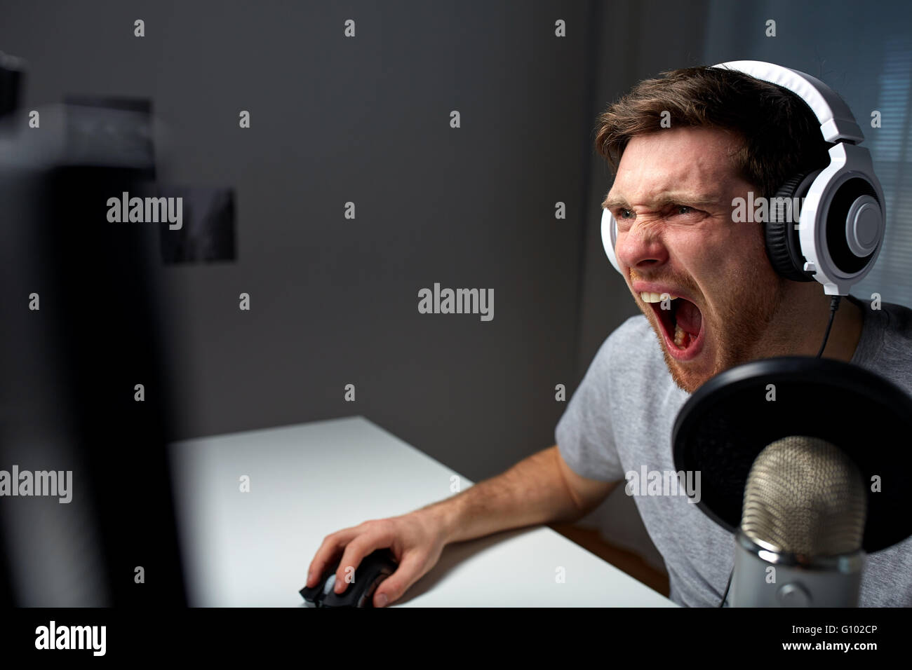 man in headset playing computer video game at home Stock Photo - Alamy