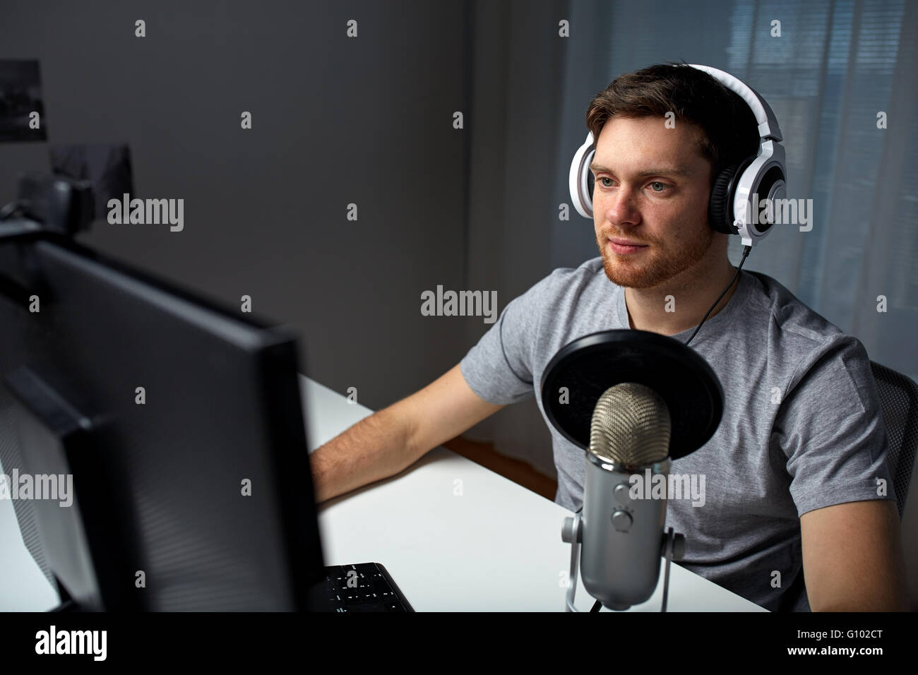 man in headset playing computer video game at home Stock Photo - Alamy