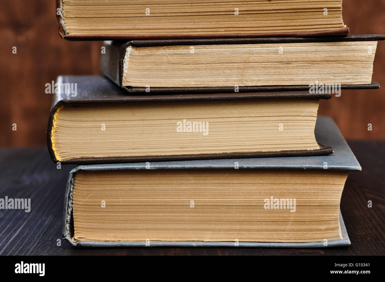 Pile of four old books on a wooden table, close-up Stock Photo - Alamy