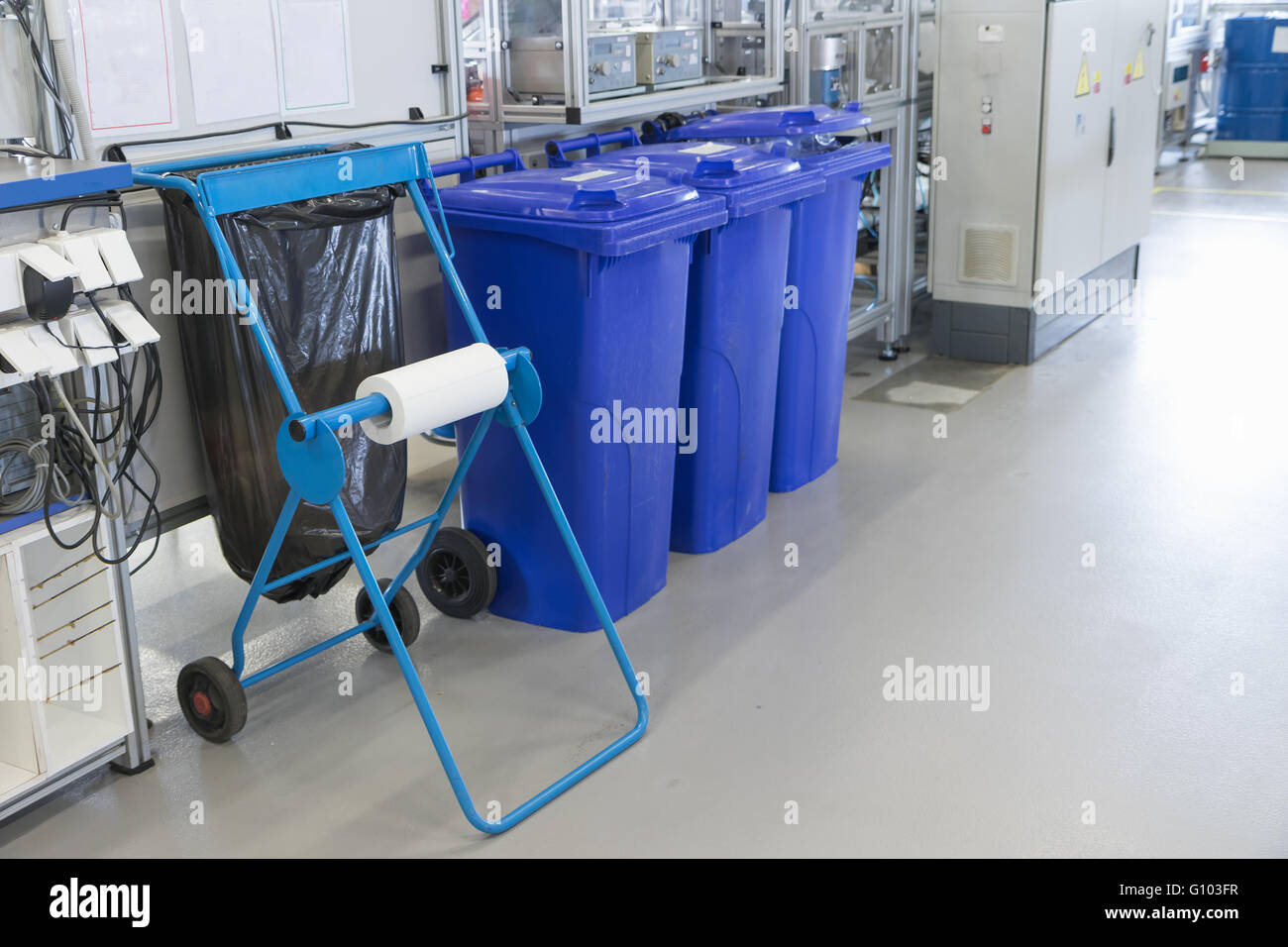 Sorting of waste into the prepared blue bins in the production hall of ...