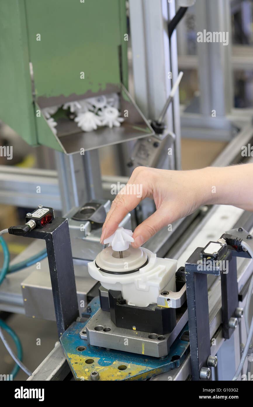 Hand of woman worker is deploying movable element on the plastic ...